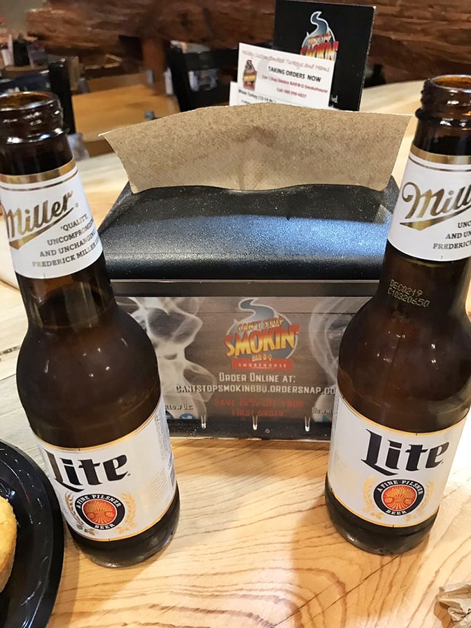 Cold beers flanking a napkin holder at Can't Stop Smokin' BBQ &ndash; the perfect companions for serious barbecue business.