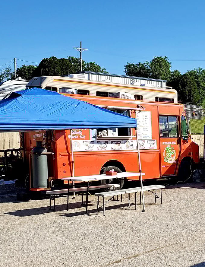 The bright orange food truck serves as both landmark and lunch spot. Follow your nose to Mexican street food that puts mall food courts to shame.