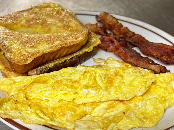The breakfast trinity: golden French toast, fluffy scrambled eggs, and bacon cooked exactly how bacon should be&mdash;crispy enough to snap, tender enough to savor.