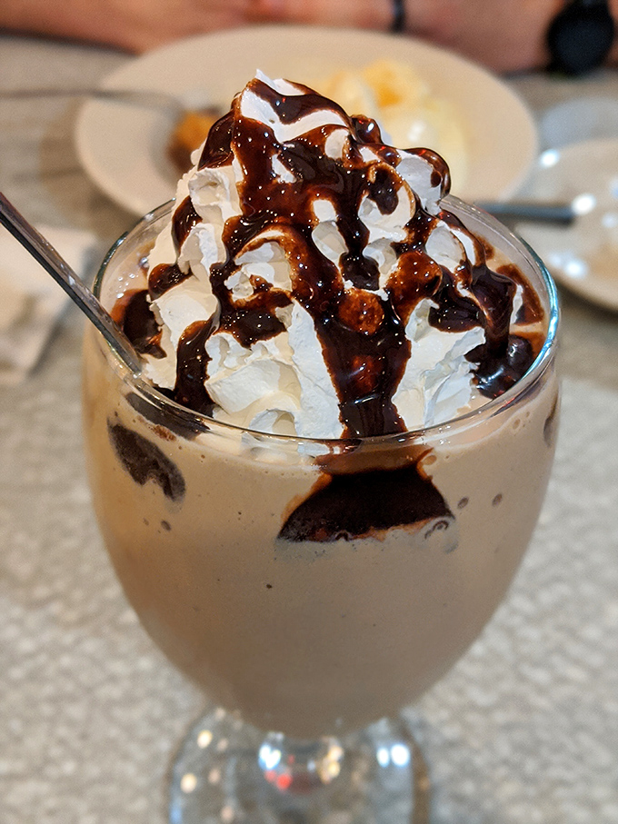 This isn't just a milkshake; it's a chocolate-drizzled monument to dairy perfection in glassware form.