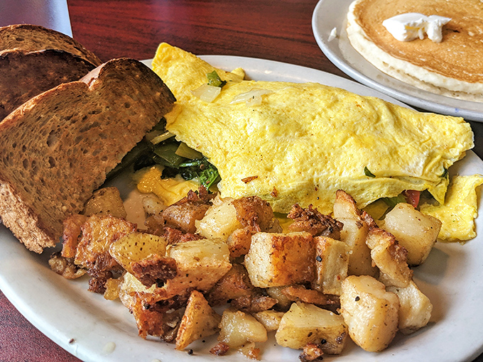 An omelet that's seen the world &ndash; spinach, cheese, and perfectly crisped home fries that deserve their own zip code.
