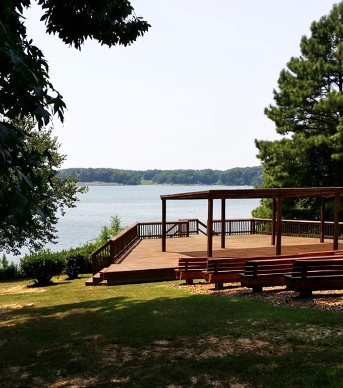 This wooden deck isn't just a viewing platform; it's nature's theater balcony where the lake performs daily shows of shimmering brilliance.