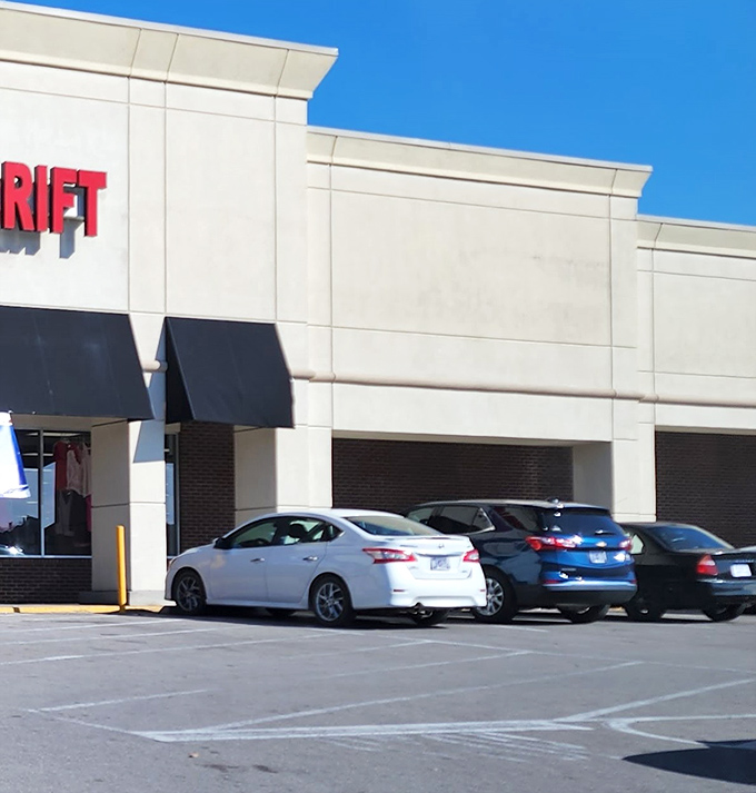 The unassuming exterior hides a universe of possibilities inside, where cars park and shoppers emerge with unexpected treasures.