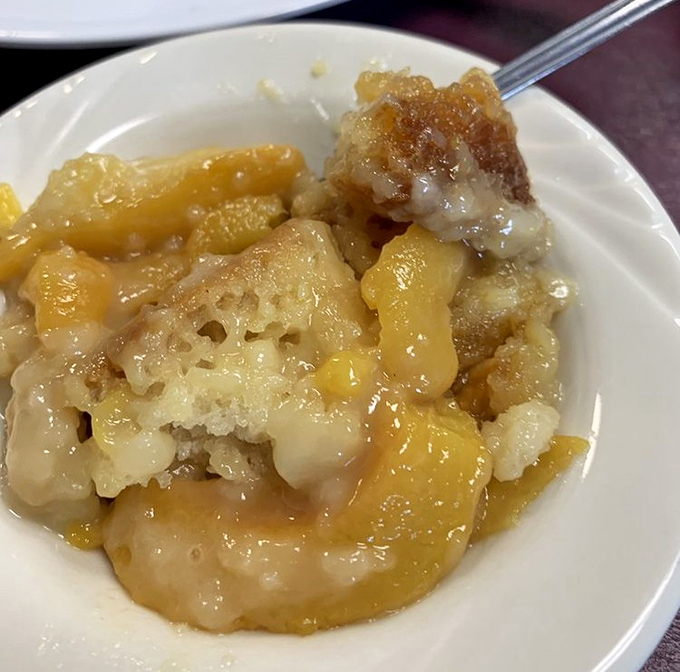 Peach cobbler that would make your grandmother simultaneously proud and jealous. The steam rising is nature's way of applauding.