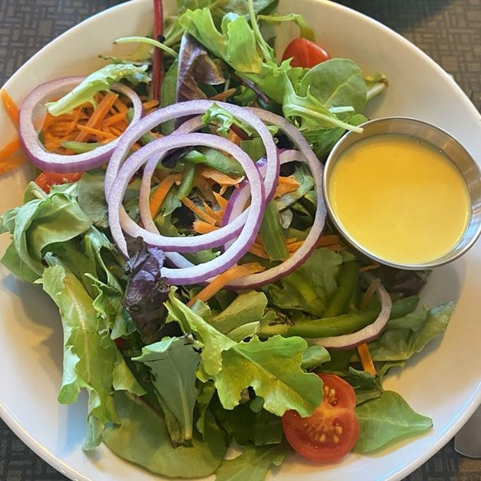 Even the salad gets the Maryland treatment&mdash;crisp greens, vibrant veggies, and that sunshine-yellow dressing promising tangy delight.