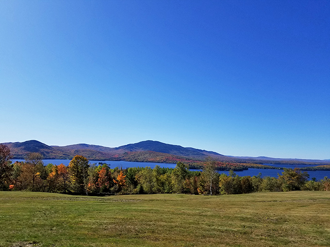 Fall foliage frames Moosehead Lake like nature's own masterpiece – no filter needed for this spectacular autumn view.