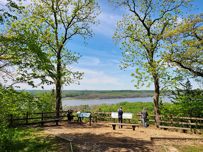 The best conversations happen at overlooks. These visitors have found the sweet spot where nature provides both the view and the topic of discussion.