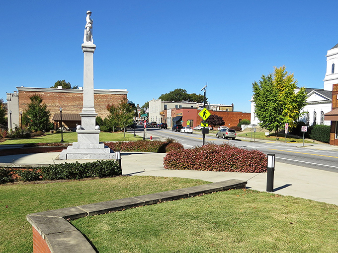Historic monument stands tall in downtown Carrollton, where brick buildings and blue skies create small-town perfection.