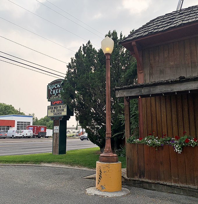 Rock Creek's vintage sign and classic lamppost hint at the old-school steakhouse experience waiting inside.