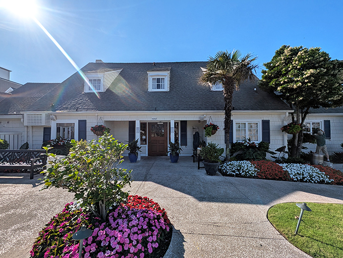 Sea Captain's House looks like a postcard-perfect coastal cottage, surrounded by colorful flowers that welcome you home.