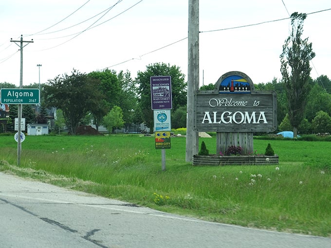 The "Welcome to Algoma" sign promises small-town treasures without tourist traps. This is the real Wisconsin.