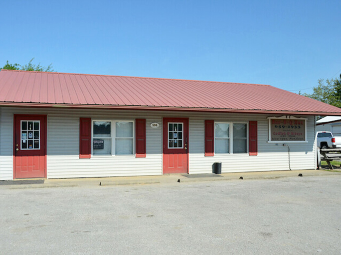 The metal roof and modest signage of Bar-B-Q Hut whisper rather than shout. The BBQ inside does all the talking needed.