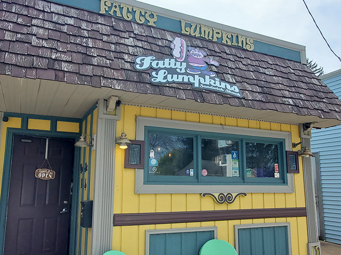 The cheerful yellow exterior and quirky name hint at the creative sandwich magic happening inside this Muskegon gem.