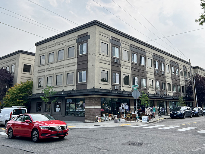 Downtown Olympia&rsquo;s lively corner hosts vintage finds and local vendors beneath a modern building backdrop.