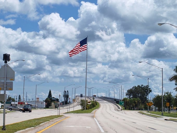 The bridge to Moore Haven rises like a promise—beyond it lies affordable waterfront living and bass fishing that would make your grandfather weep with joy.