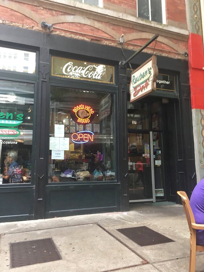 Those vintage Coca-Cola signs and traditional storefront scream authentic American deli culture at its finest.