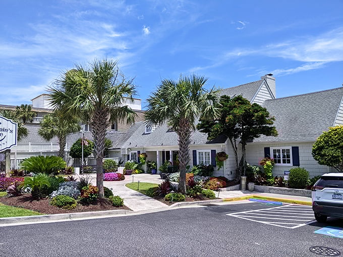 Palm trees and pristine landscaping frame the charming Sea Captain's House, a Myrtle Beach landmark that's weathered many a storm.