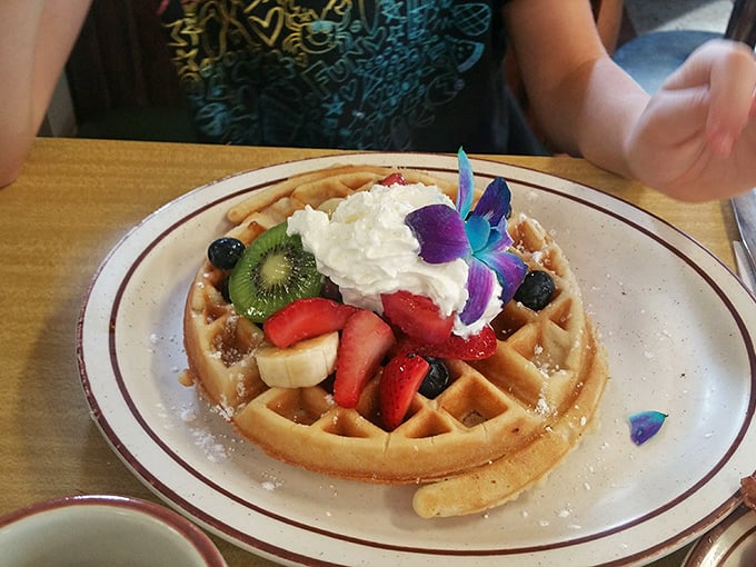 A waffle that dresses for the occasion, topped with a fruit medley and whipped cream that transforms breakfast into a celebration worthy of that fancy orchid.
