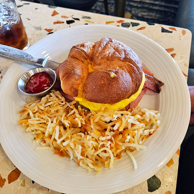 Breakfast that understands the importance of proper architecture &ndash; egg, ham, and cheese nestled in a croissant that clearly went to pastry school.