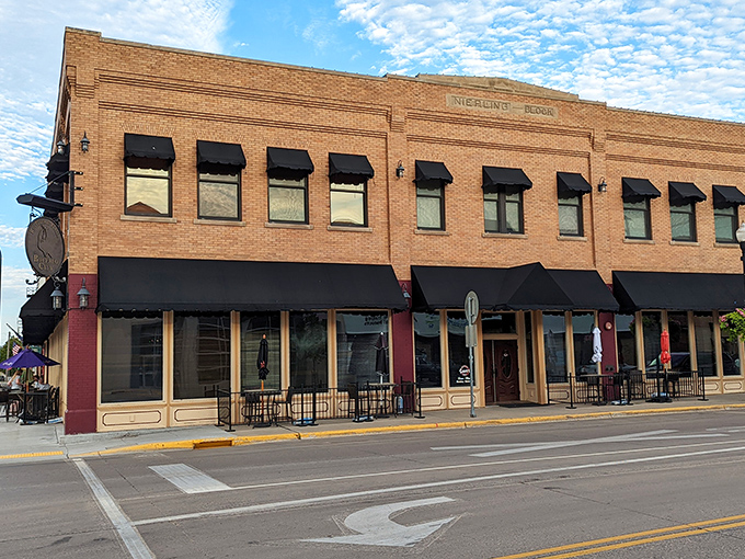 The Nicolin Room's classic brick facade and black awnings promise the kind of dining experience where calories don't count because you're "on vacation."