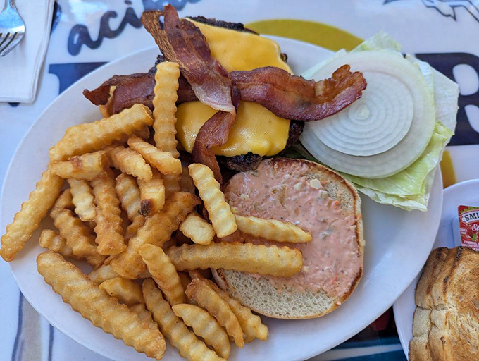 The classic diner burger and fries—where the cheese melts just right, the bacon curves with attitude, and the fries outnumber your best intentions.