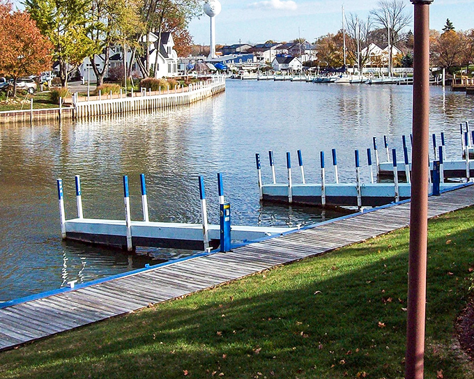Fall paints Vermilion in golden hues as empty docks await next season's boats. The calm water mirrors the shoreline homes like nature's own Instagram filter.