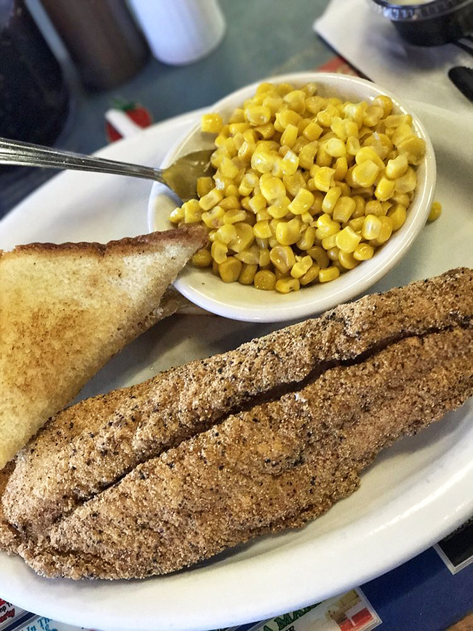 Crispy cornmeal-crusted catfish with buttery toast and sweet corn &ndash; a plate that whispers "Missouri" in the most delicious Southern accent imaginable.