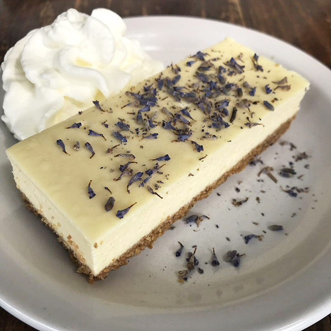 A slice of cheesecake adorned with lavender petals&mdash;proof that even in the Last Frontier, dessert sophistication has found its way north.