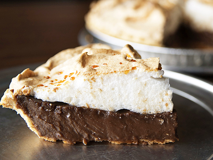 Chocolate pie with mile-high meringue—the kind grandmothers fight over at church potlucks and grown men dream about at night.