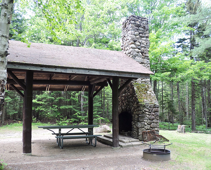 Stone fireplace meets picnic shelter&mdash;the perfect marriage of rustic charm and practical design for s'mores enthusiasts everywhere.