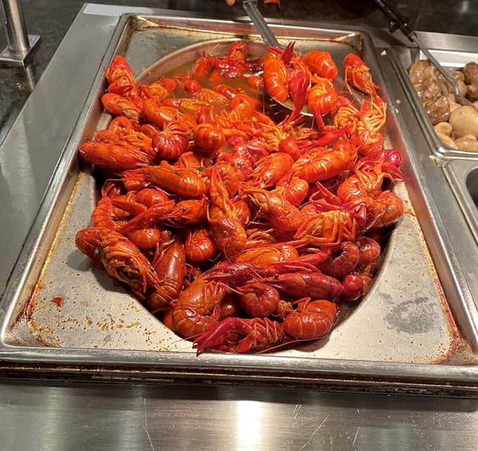 A mountain of bright red crawfish demands your attention and patience—tiny packages of flavor worth the effort of unwrapping each one.