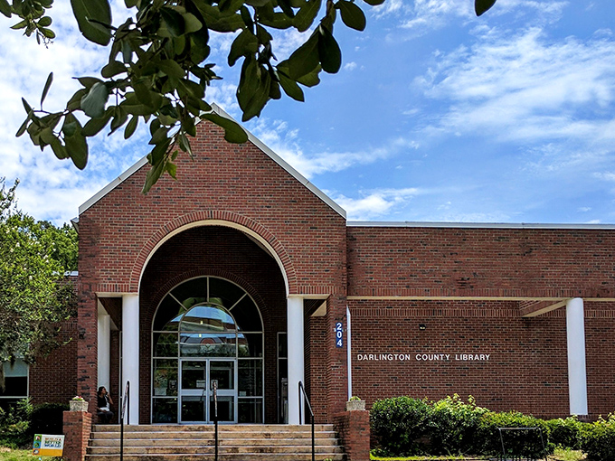 The Darlington County Library welcomes knowledge-seekers with its inviting brick fa&ccedil;ade and arched entrance &ndash; proof that the best adventures often begin between pages.