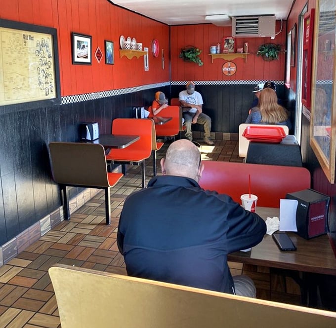 The dining room&mdash;where strangers become neighbors over the universal language of "mmm." Orange booths have witnessed countless food epiphanies.