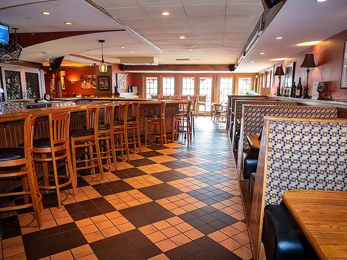 The bar area beckons with warm woods and checkered floors&mdash;a space where "I'll just have one drink" becomes a delightful evening.