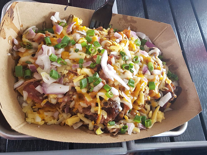 Frito pie elevated to art form: layers of chips, meat, cheese, and toppings creating a symphony of textures that Mozart would have appreciated.