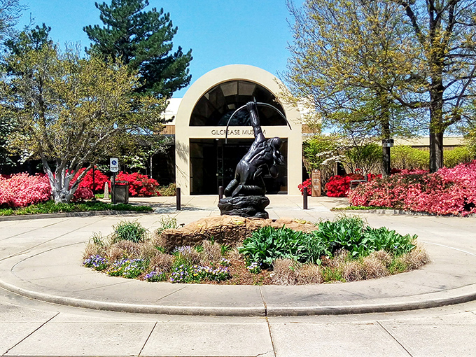 The Gilcrease Museum entrance, framed by blooming azaleas, invites visitors to explore America's most comprehensive collection of Western art.
