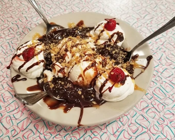 This hot fudge brownie sundae isn't just dessert—it's an architectural marvel of ice cream, whipped cream, and chocolate that demands to be photographed first.