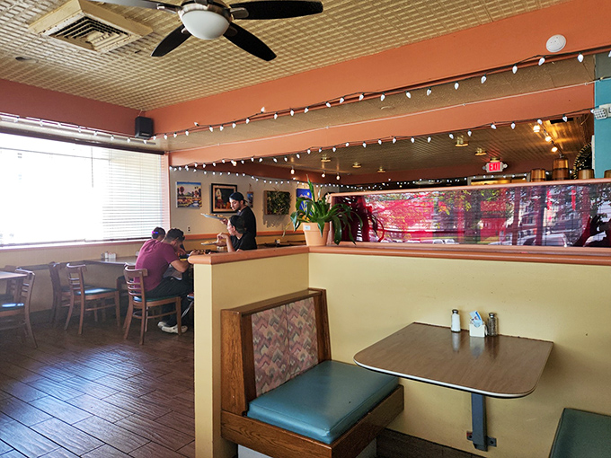 The dining room's warm coral walls and string lights create an atmosphere that says, "Stay awhile&mdash;there's another plate calling your name."