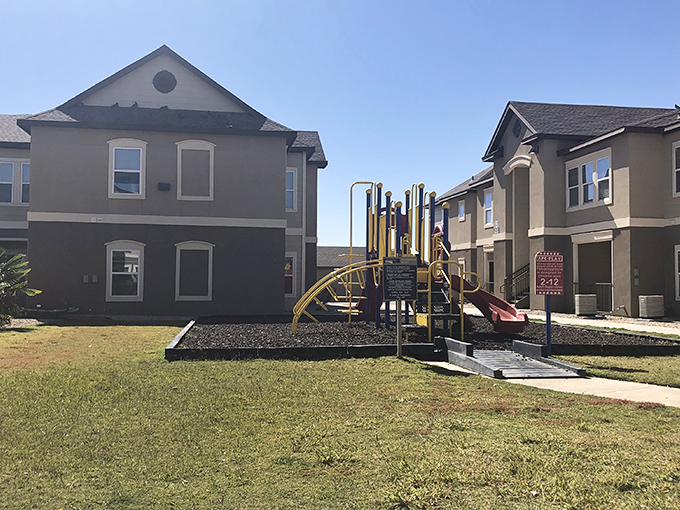 Even apartment living in Lovington embraces community spirit with thoughtfully designed outdoor play spaces between residential buildings.