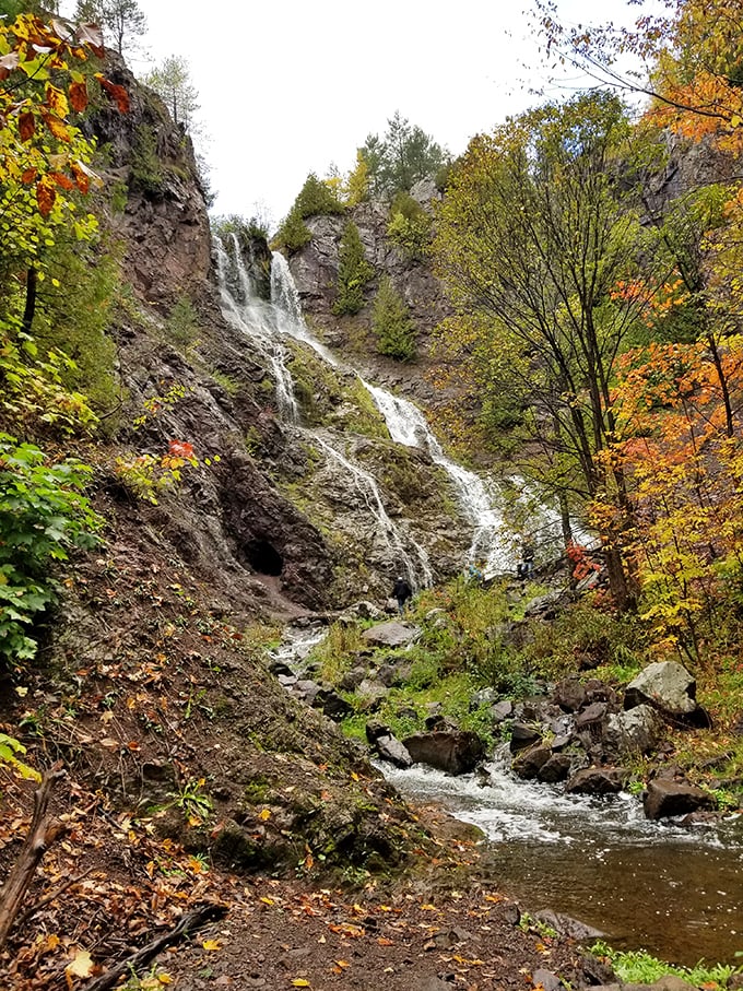 Manganese Falls cascades through autumn's palette, a hidden reward for hikers willing to venture beyond the harbor.