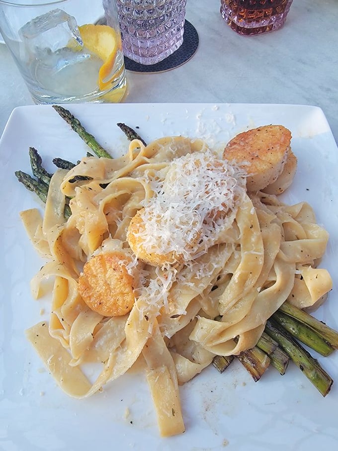 Pasta with scallops and asparagus, topped with enough cheese to make any Italian grandmother nod approvingly from across the Atlantic.