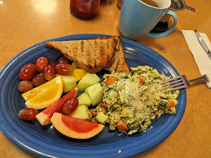 A scramble that eats like a garden—fresh vegetables, perfectly cooked eggs, and toast ready to dive into this colorful breakfast pool.