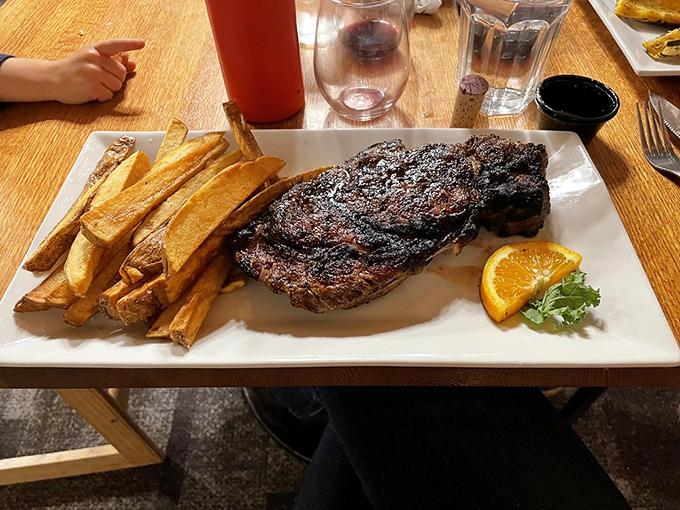 A ribeye that doesn't just occupy the plate&mdash;it conquers it, with fries standing guard like delicious golden sentinels.