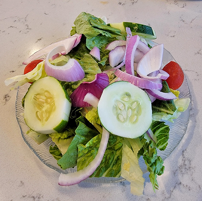 A garden-fresh salad that actually looks like someone cared&mdash;crisp cucumbers, vibrant tomatoes, and red onions with just enough bite.