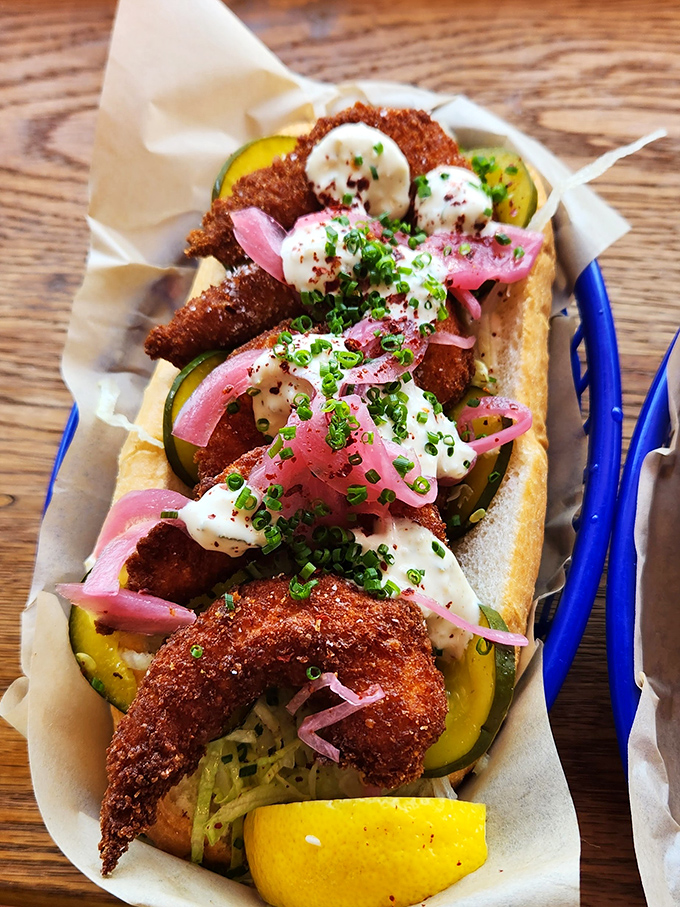 These crispy shrimp nestled in their roll with pickled onions and fresh herbs aren't just seafood&mdash;they're edible jewelry, meticulously crafted and destined for Instagram before your stomach.