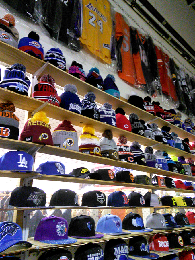 Sports fan paradise where team loyalty lines the walls. The hat you choose says more about you than your dating profile.