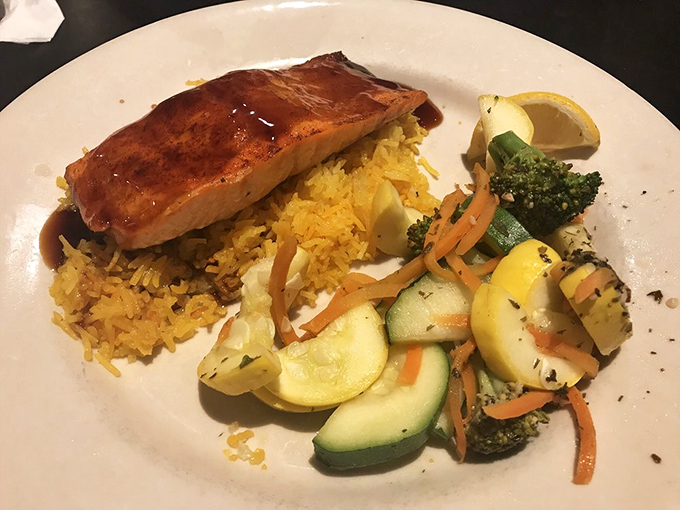 Salmon that doesn't need to hide behind heavy sauces – Tucker's teriyaki version sits atop saffron rice with vegetables that actually taste like vegetables.