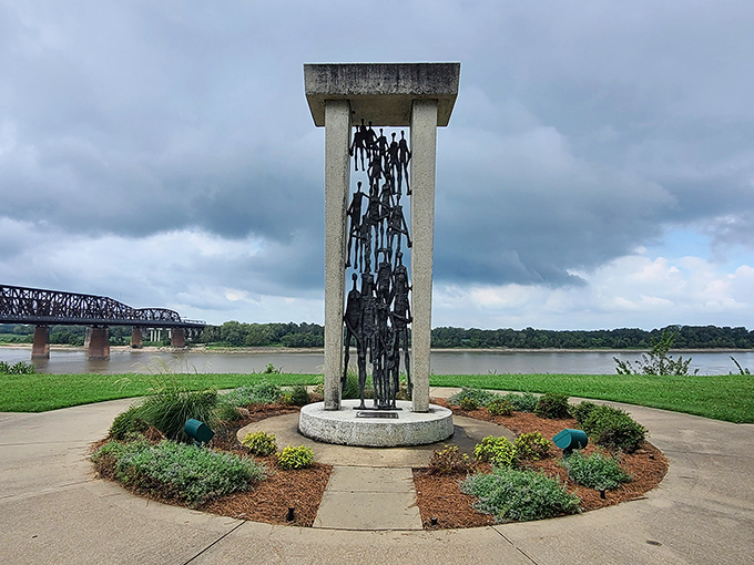 This riverside memorial sculpture stands as a solemn reminder of Memphis's complex history, framed by the mighty Mississippi that shaped the city.