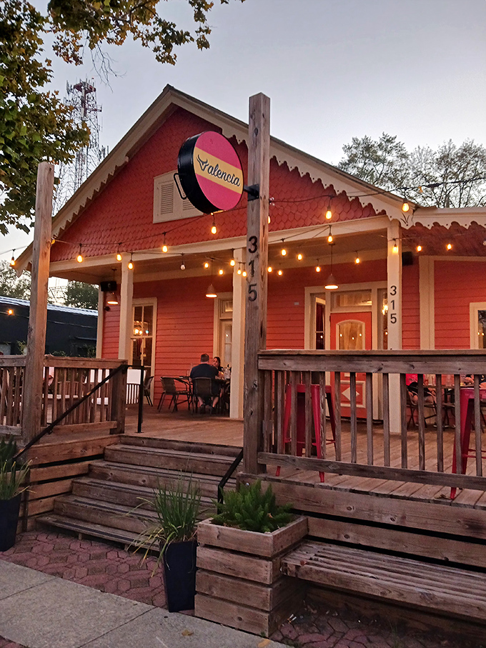 Valencia's coral-colored cottage glows at dusk, promising the kind of evening where conversations flow easier than the wine.