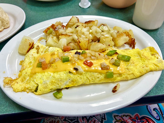 An omelet that proves vegetables can party too – cheese, peppers, and onions having their morning get-together.